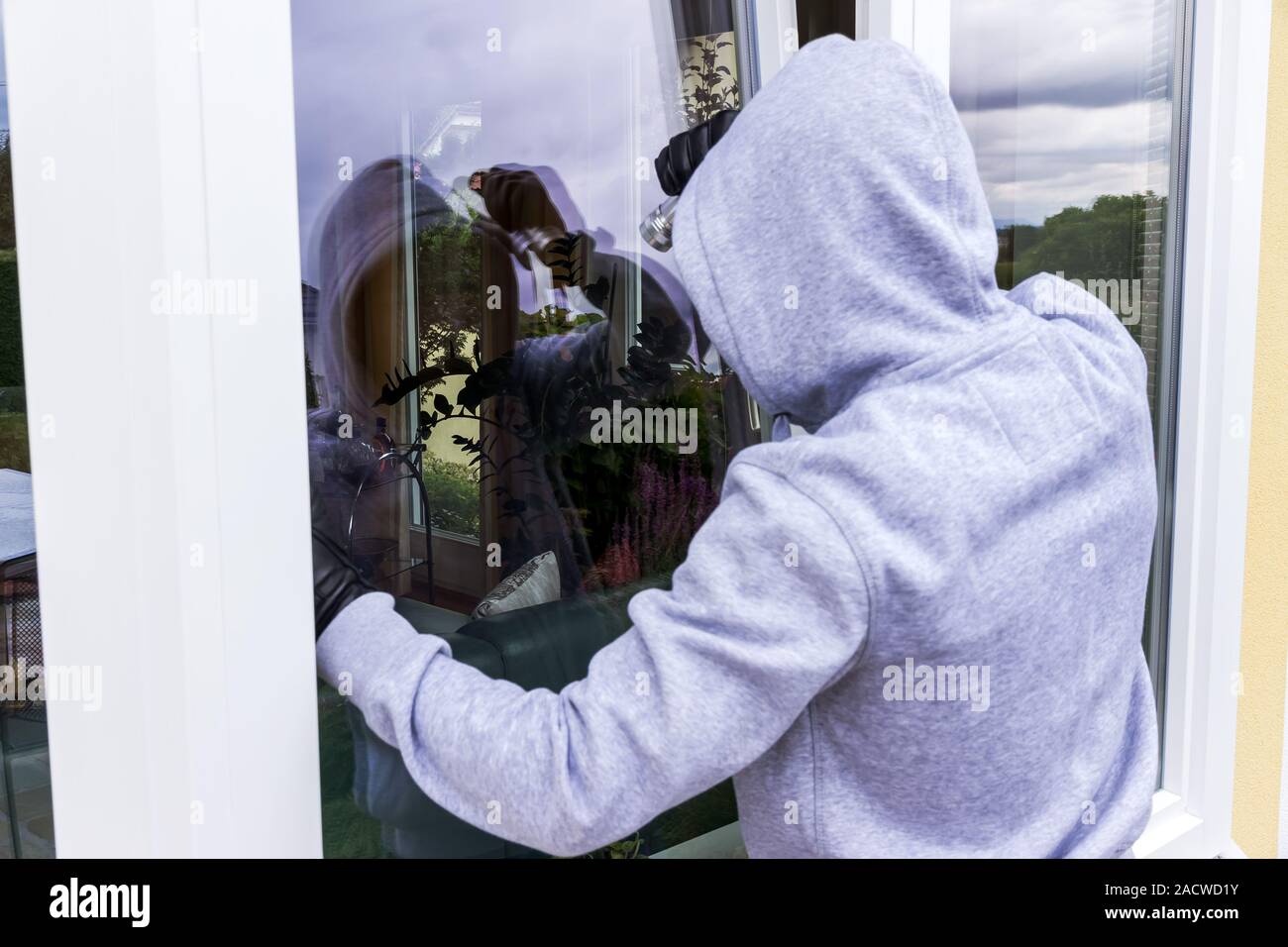 Burglar at a window Stock Photo - Alamy