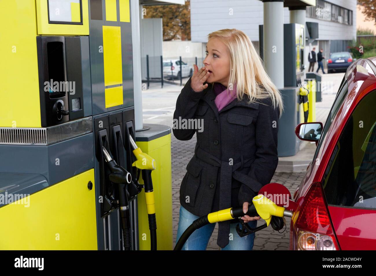 Woman refueling at a gas station Stock Photo - Alamy
