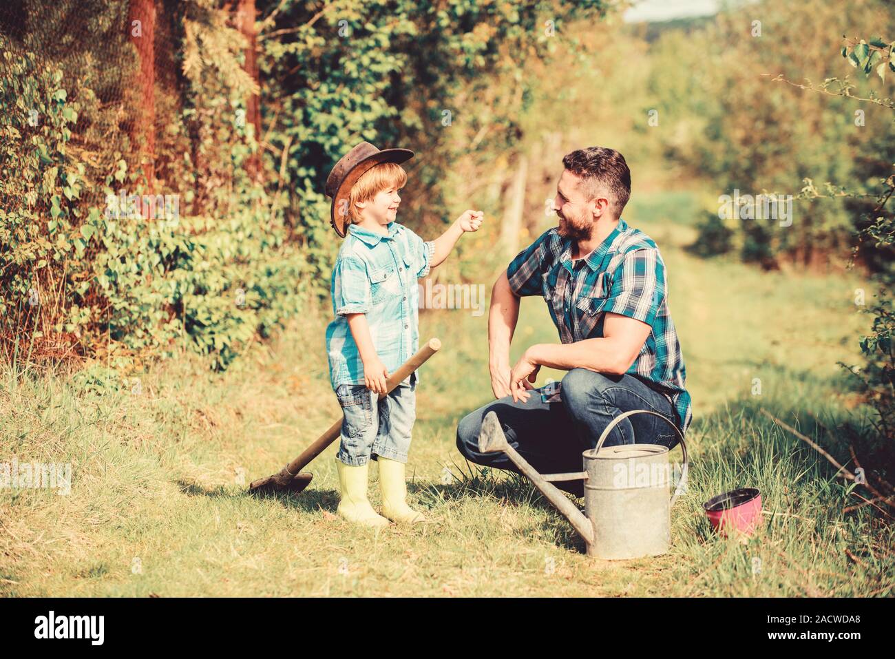 small boy child help father in farming. Eco farm. father and son in ...