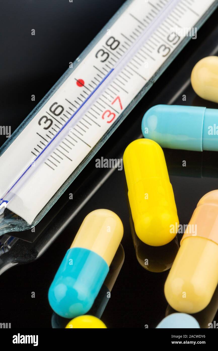 Fever thermometers and tablets Stock Photo - Alamy