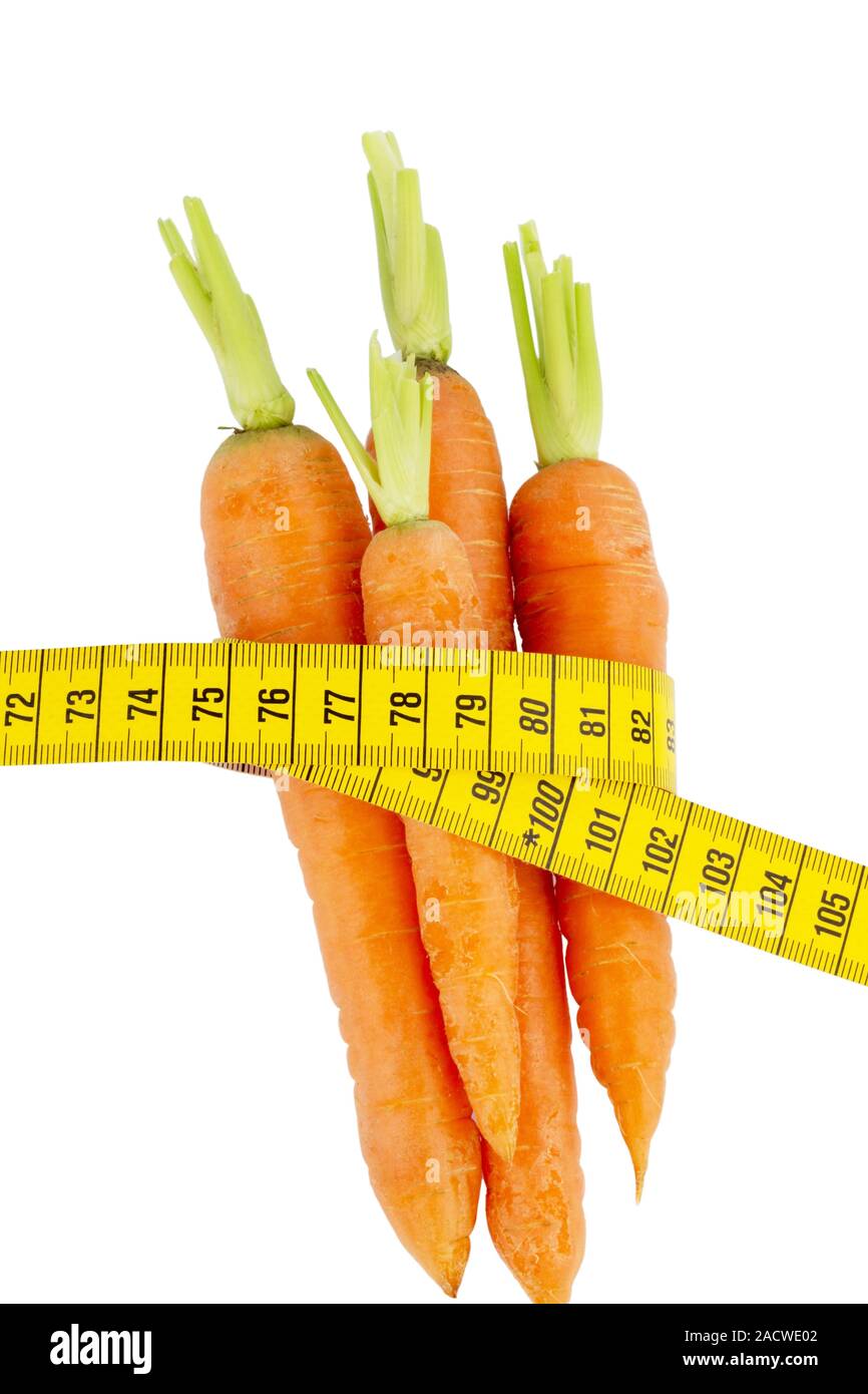 Fresh carrots with tape measure Stock Photo - Alamy