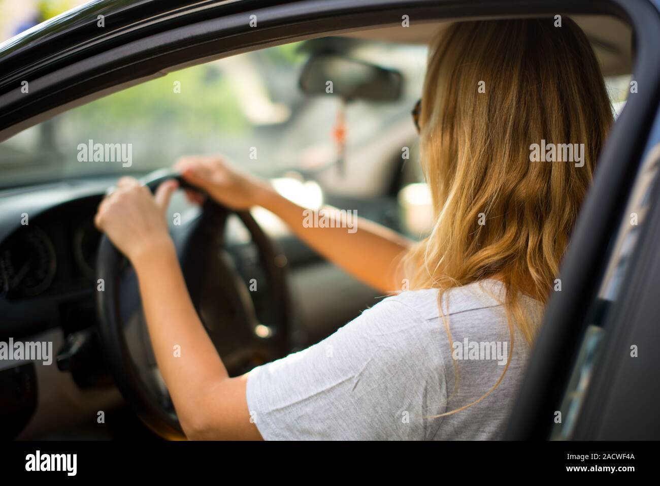 Young beautiful blonde hair girl with driving a car. Confident and ...