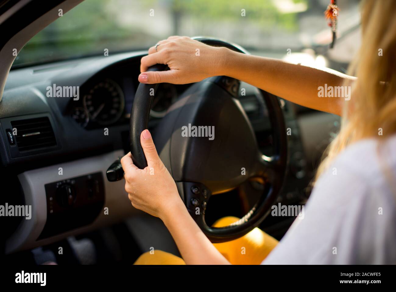 Young beautiful blonde hair girl with driving a car. Confident and ...