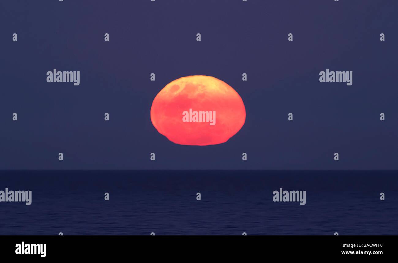 Moon rising over the sea. Photographed in August from Buenos Aires ...