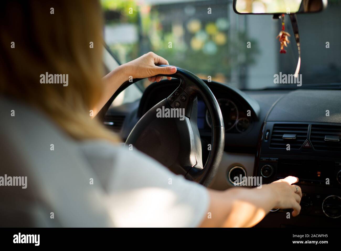 Young beautiful blonde hair girl with driving a car. Confident and ...