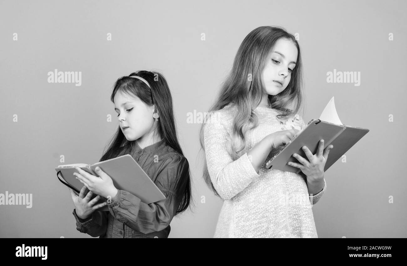 happy little children ready for school lesson. students reading a book ...