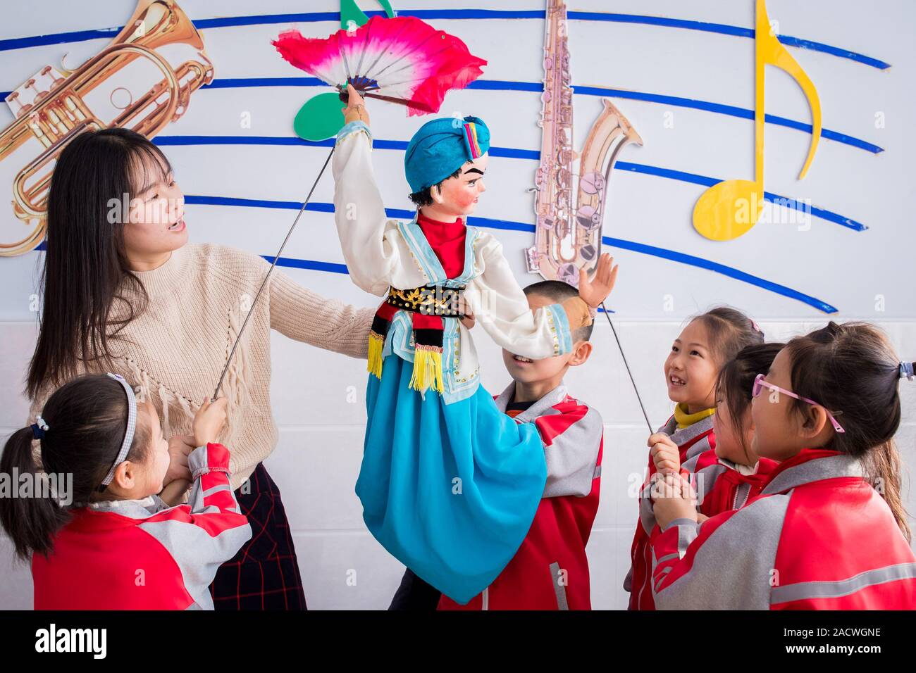 Young Chinese students play with a puppet during a presentation and ...