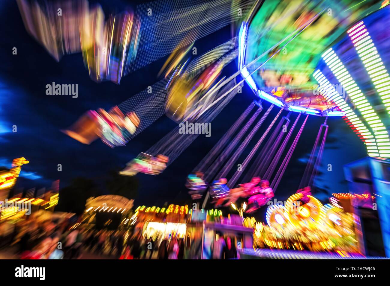 Traditional chain carousel at night Stock Photo - Alamy