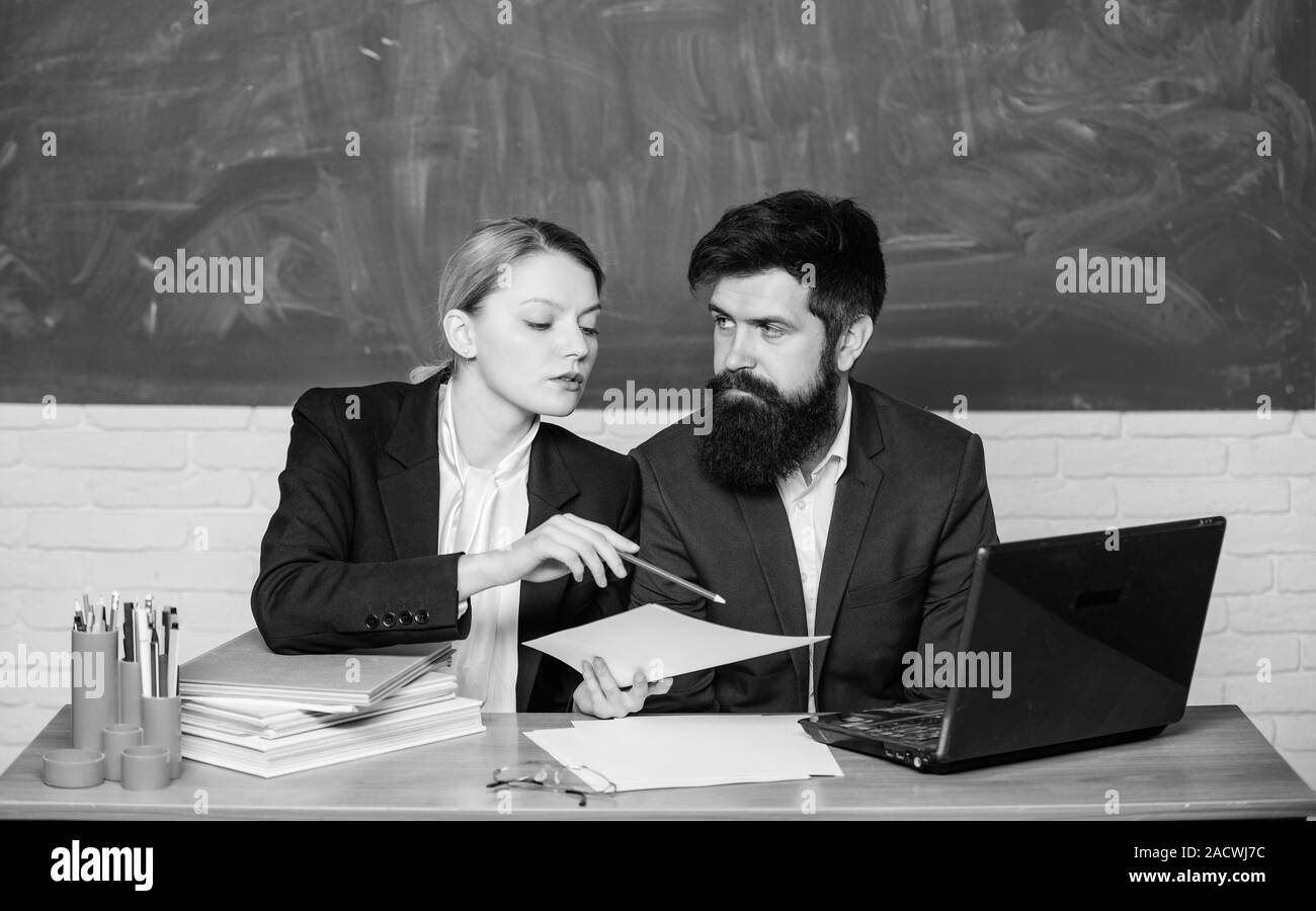 Teacher and supervisor working in school classroom. School educator ...