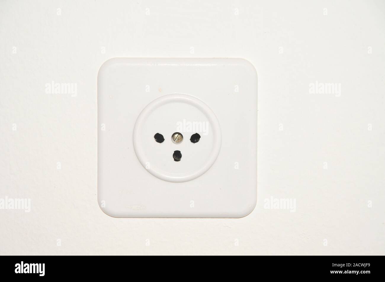 Standard Israeli three prong electric socket on white wall Stock Photo ...