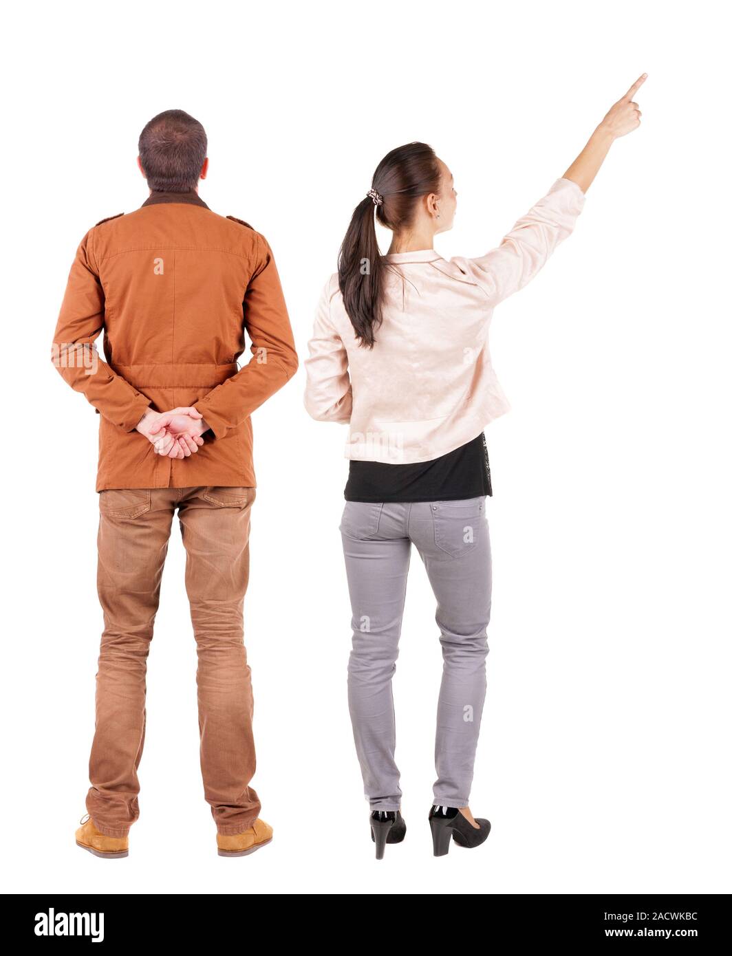 Back view of a stylish couple pointing. beautiful friendly girl and guy ...