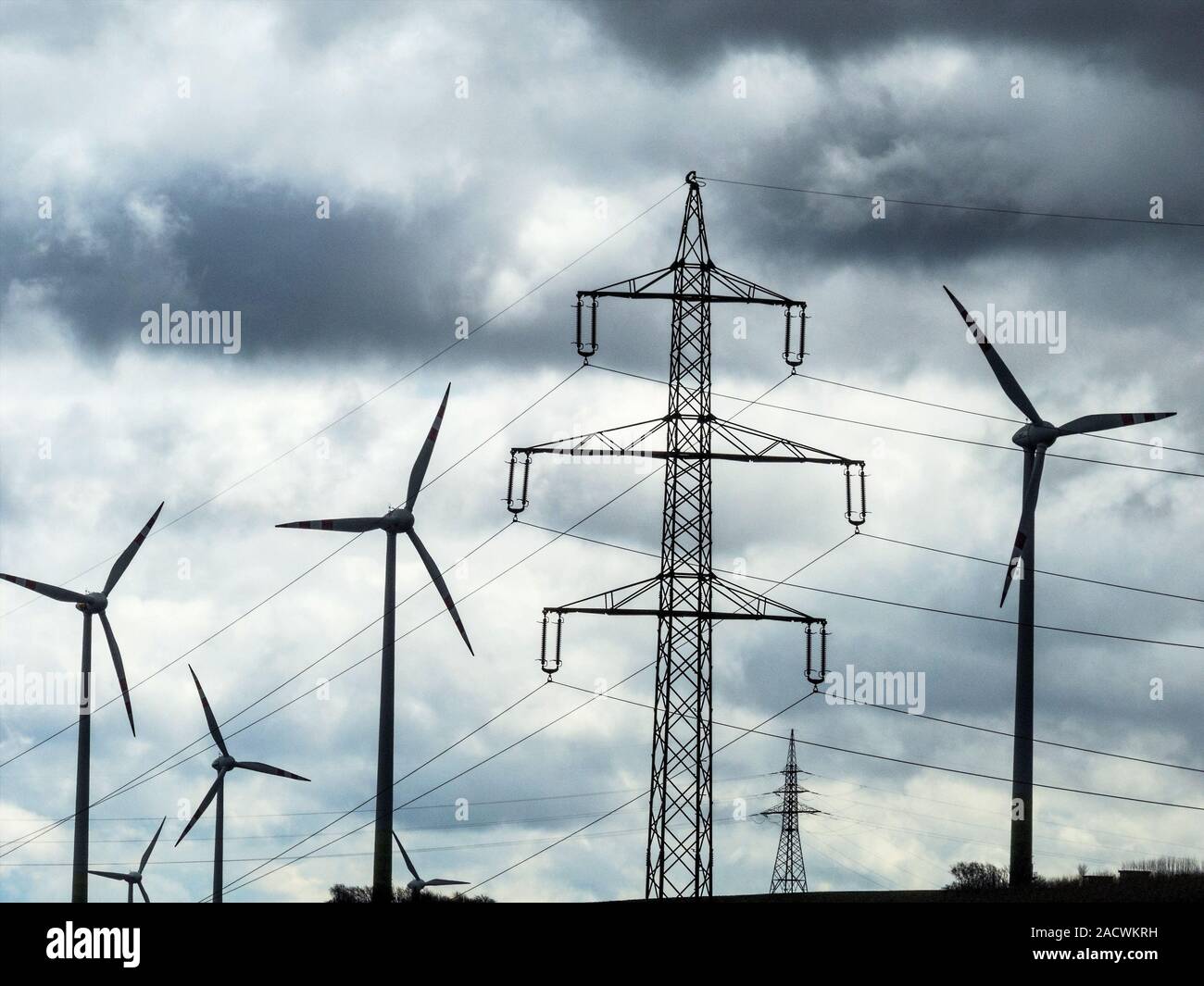 Wind turbine and power pylons Stock Photo - Alamy