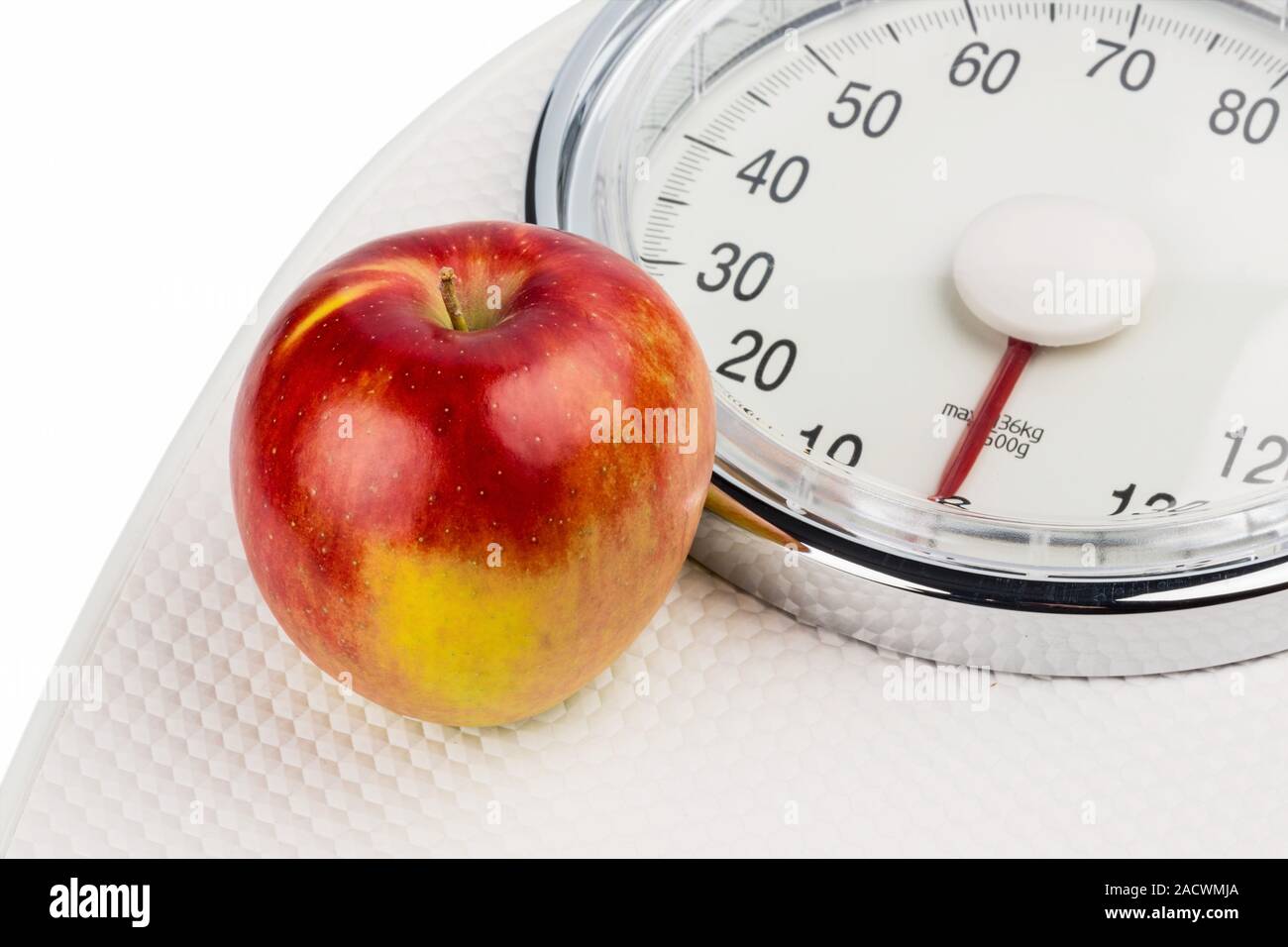 Apple lies on a scale Stock Photo - Alamy