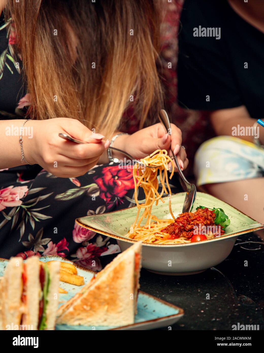 Woman eating spaghetti bolognese hi-res stock photography and images ...