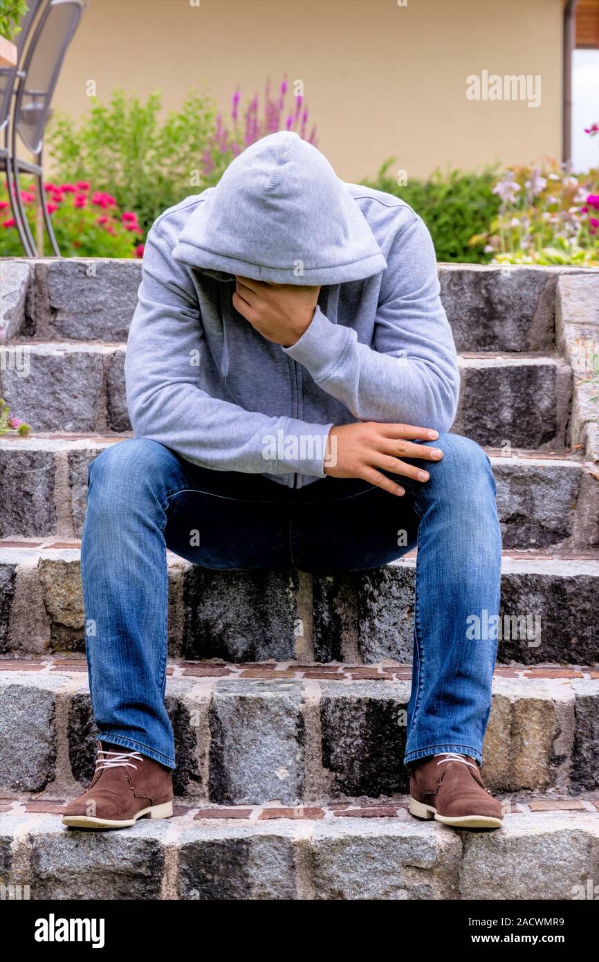Man sitting on steps Stock Photo - Alamy