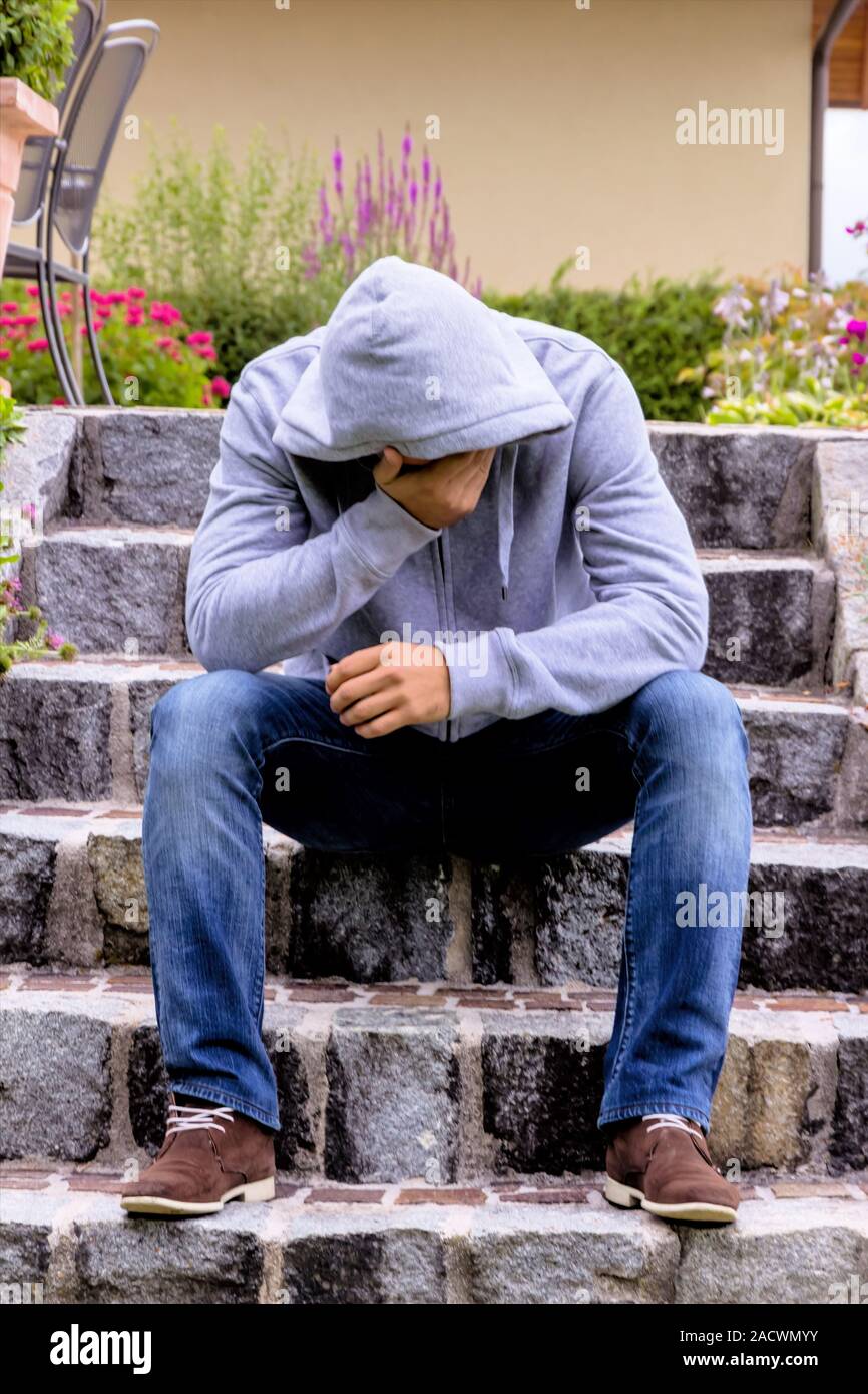 Man sitting on steps Stock Photo - Alamy