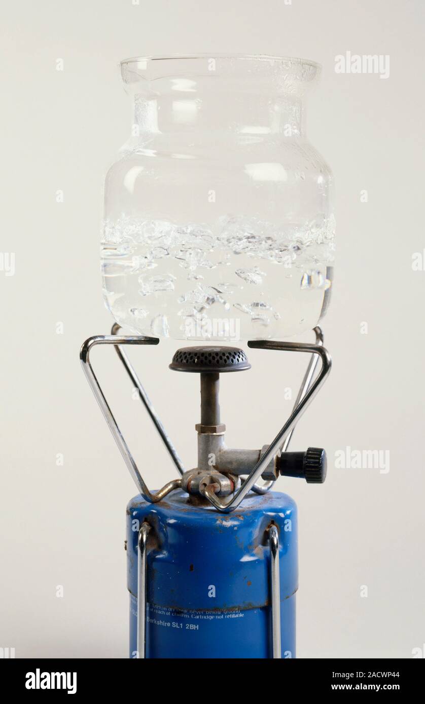 Water boiling in glass beaker on top of camping stove Stock Photo - Alamy