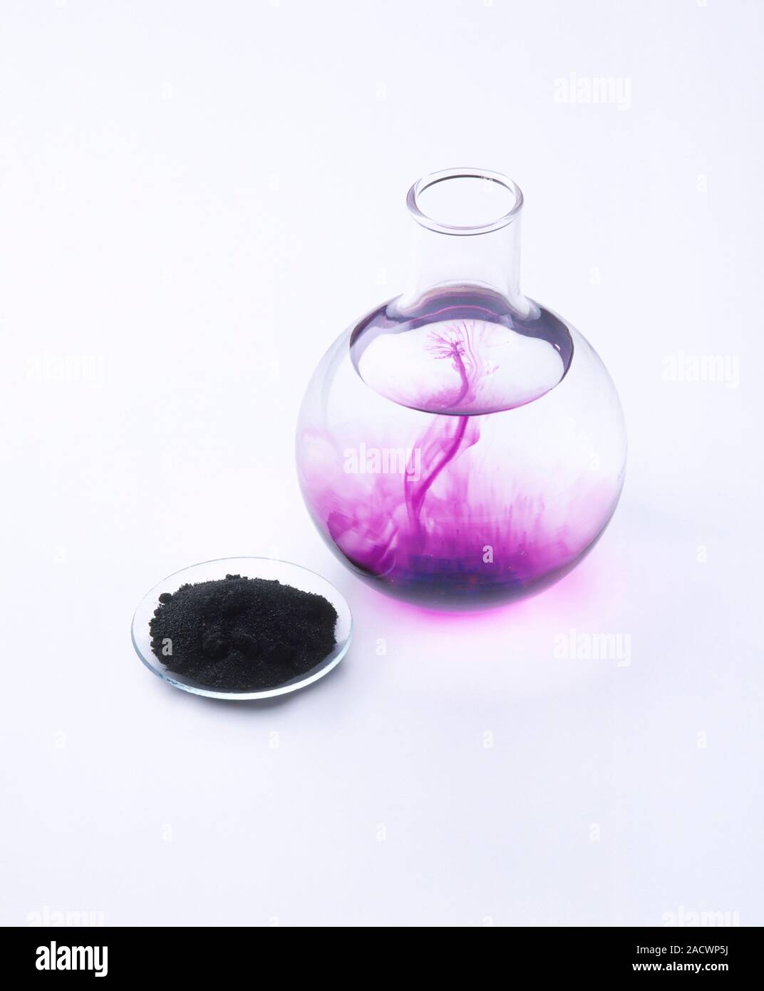 Potassium permanganate crystals in dish and dissolving in glass flask ...