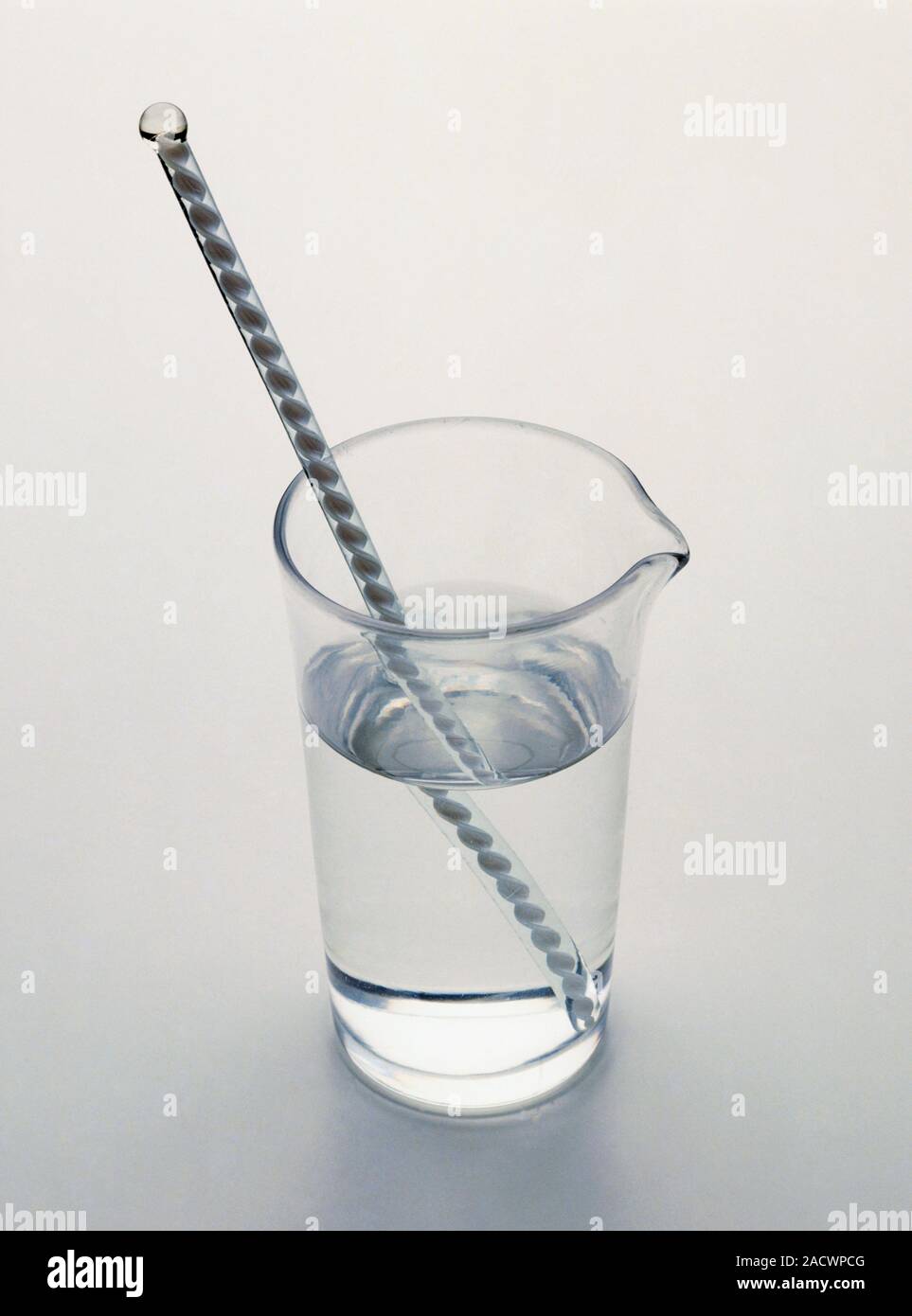 Glass rod refracted in beaker of water Stock Photo - Alamy