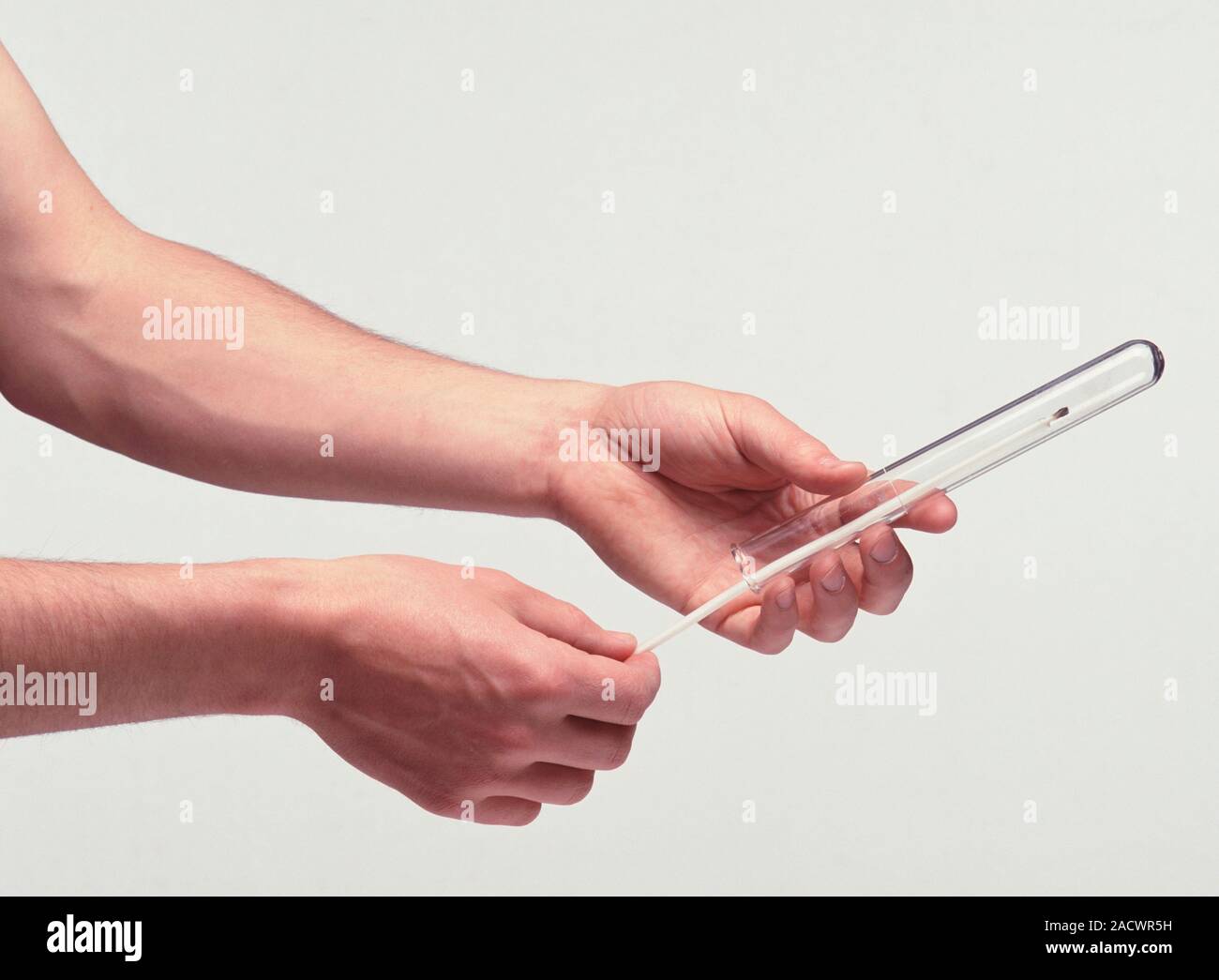 Hand holding a lit splint in a test tube Stock Photo - Alamy