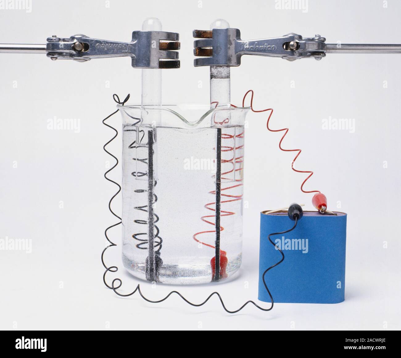 Battery connected to two electrodes in water for electrolysis Stock ...