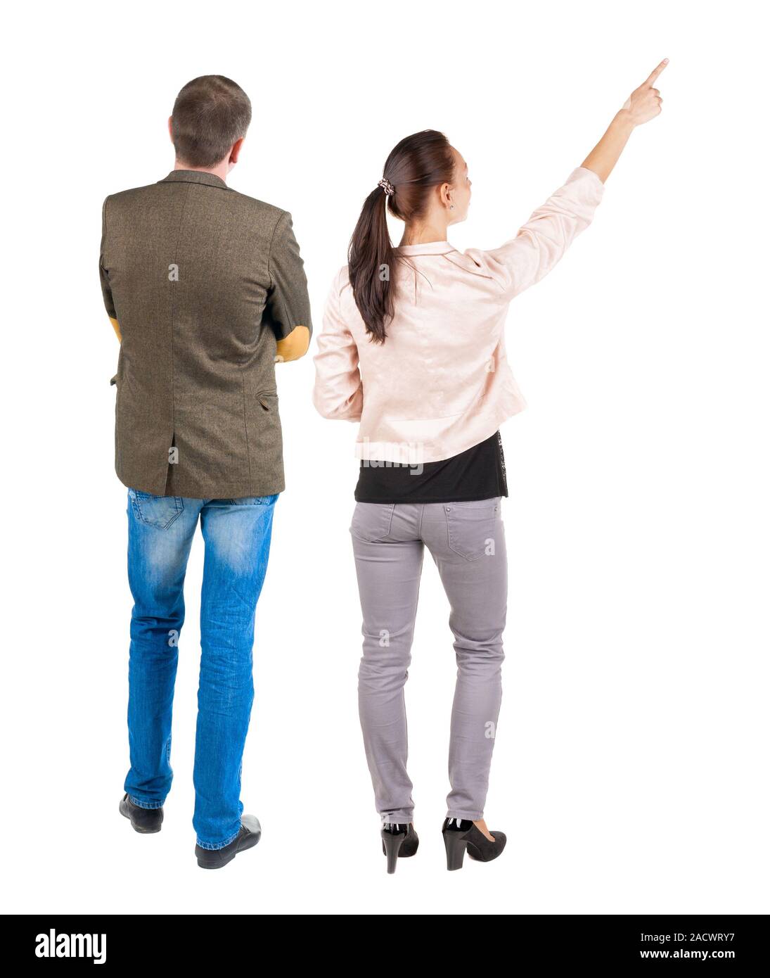 Back view of a stylish couple pointing. beautiful friendly girl and guy ...