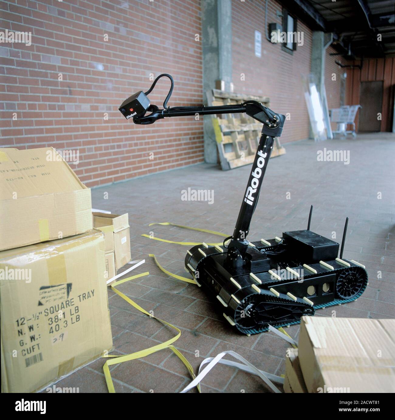 PackBot military robot using its sensor arm to investigate a suspect ...