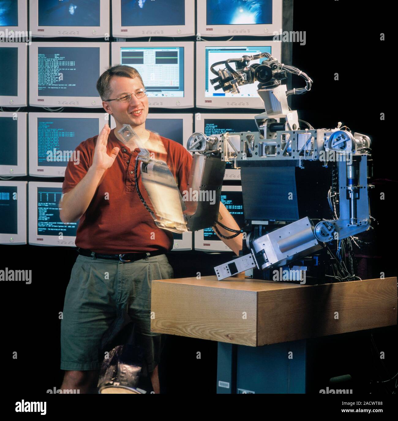 Roboticist with Cog robot. US roboticist Brian Scassellati interacting ...