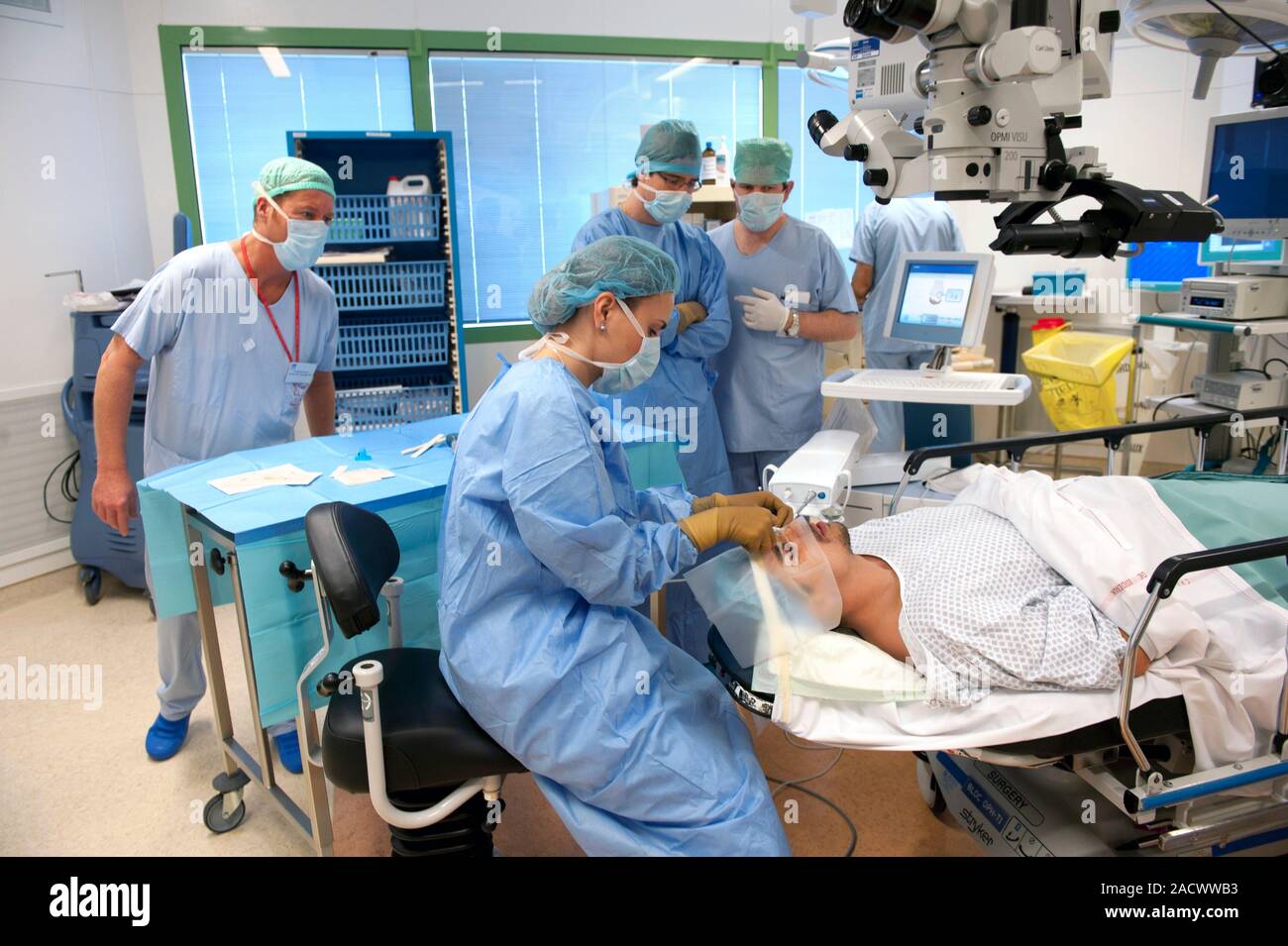 Keraflex eye operation. Surgeons carrying out an eye operation to ...