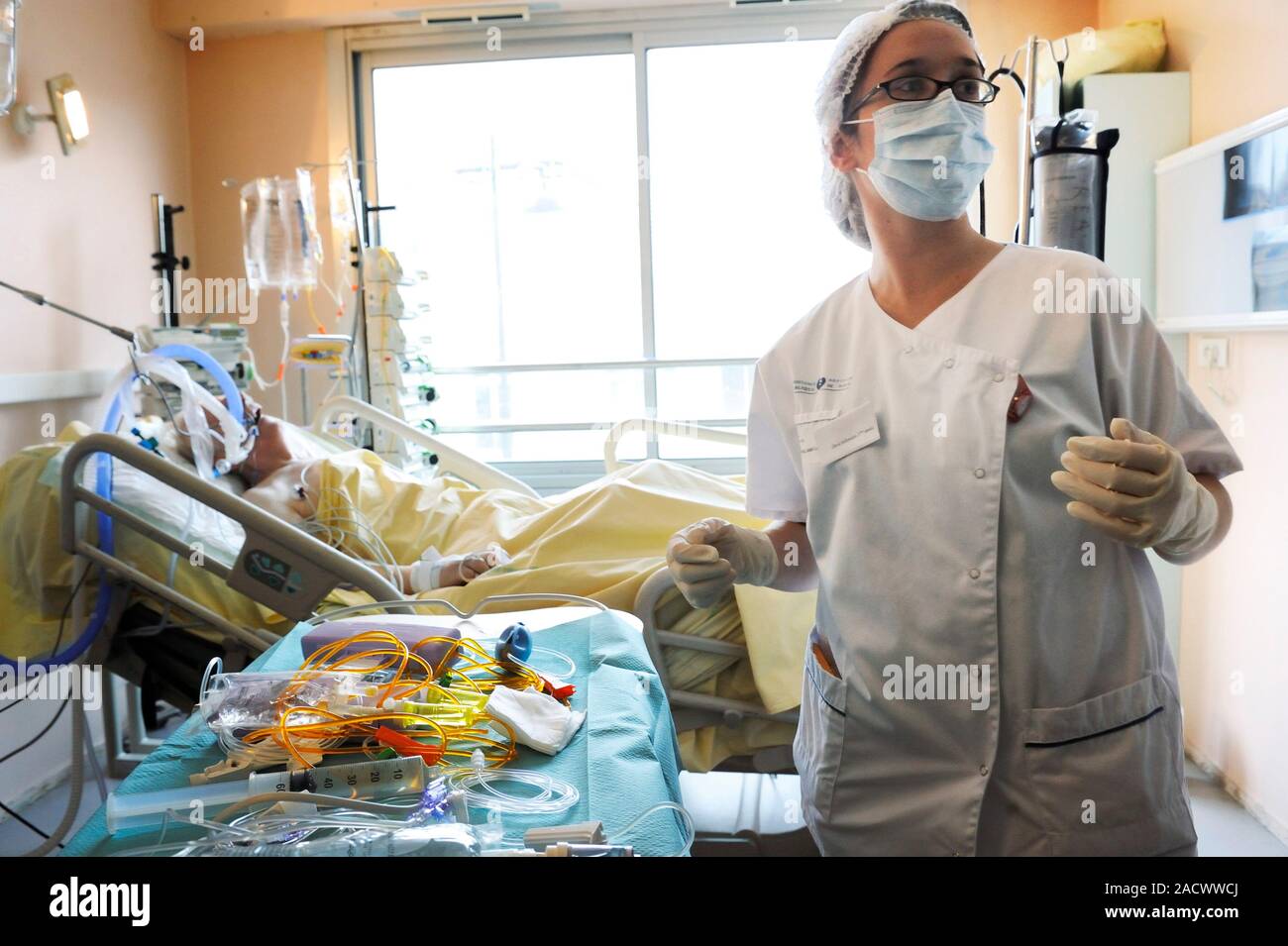 Toxicology hospital ward. Nurse caring for a patient on a hospital's ...