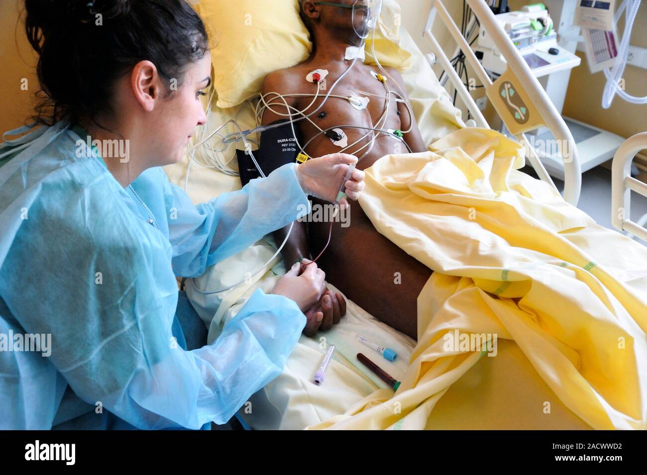 Toxicology hospital ward. Nurse collecting blood from an artery in a ...