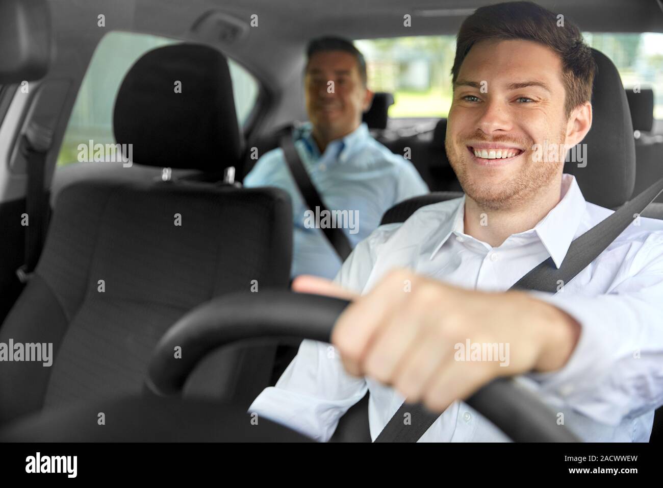transport, vehicle and taxi concept - happy smiling male driver driving ...