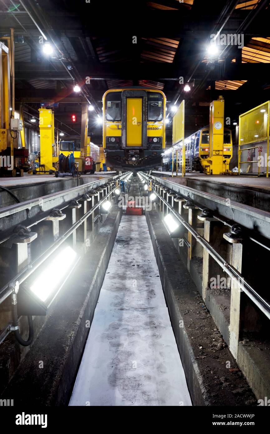 Railway service and maintenance depot with illuminated inspection pits ...