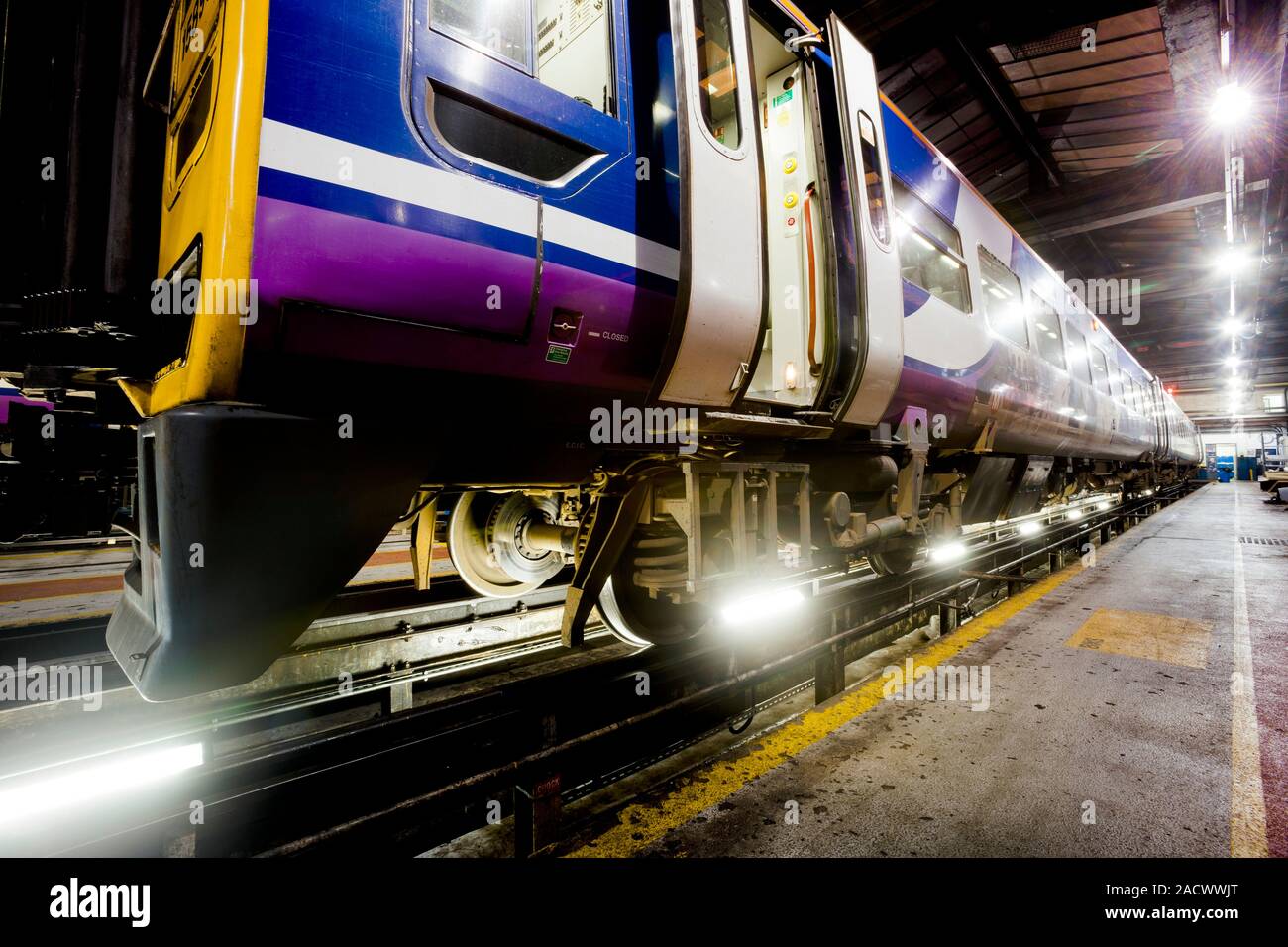 Railway service and maintenance depot with illuminated inspection pits ...