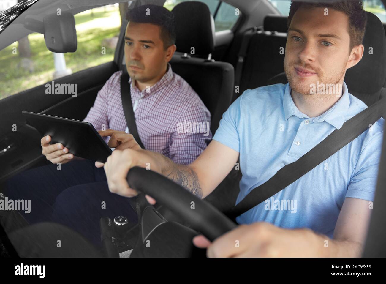 driver courses and people concept - man and driving school instructor ...