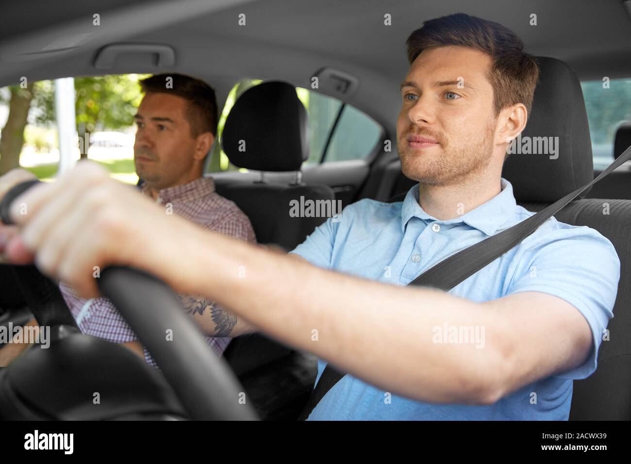 car driving lesson and carpooling concept - instructor on passenger ...