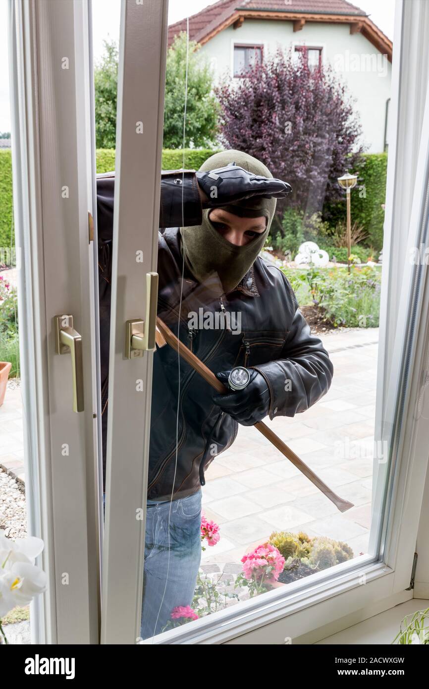 Burglar at a window Stock Photo - Alamy