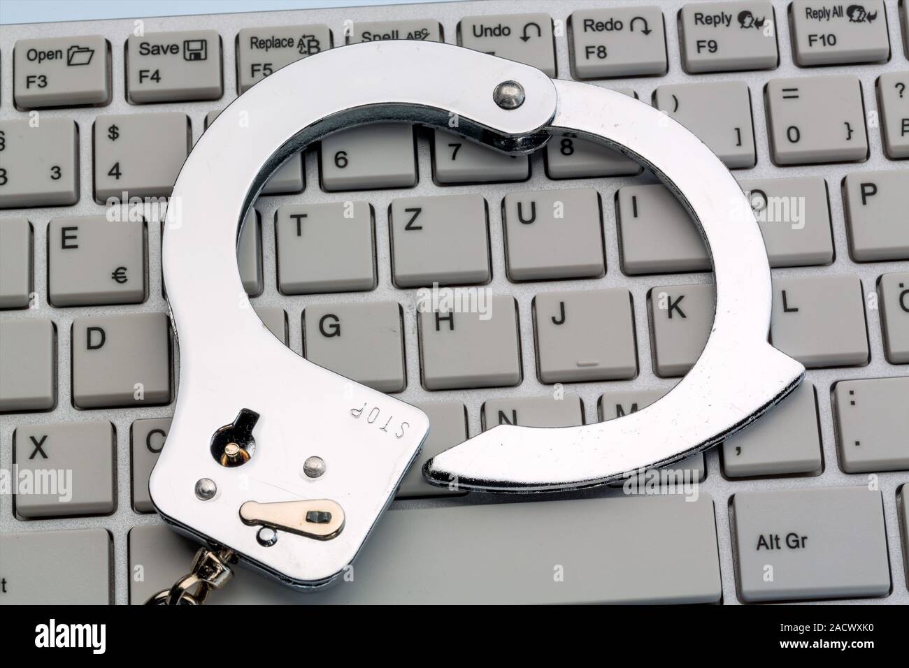 Handcuffs on Computer Keyboard Stock Photo - Alamy