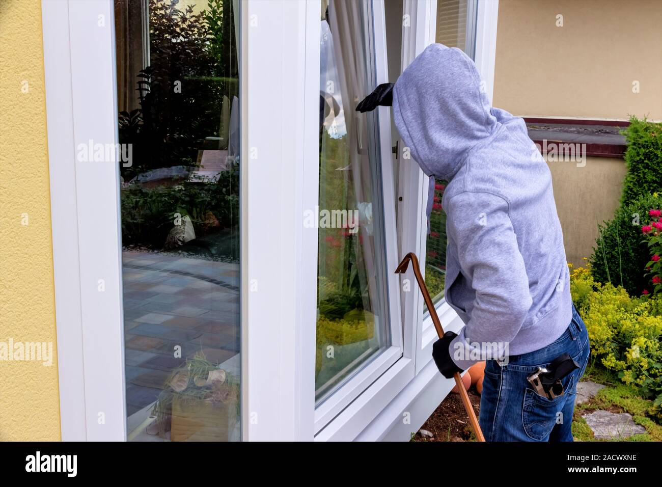 Burglar at a window Stock Photo - Alamy