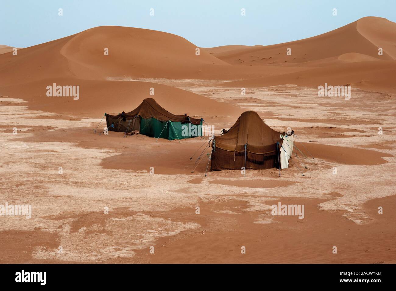 Bedouin tents and sand dunes in a desert. The Bedouin are a part of a ...
