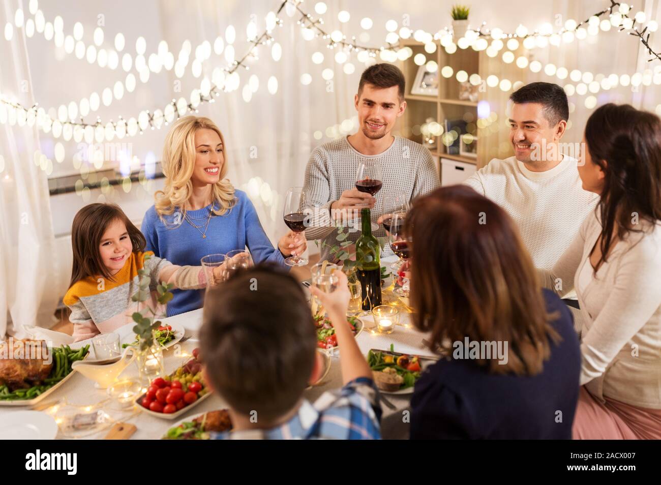 celebration, holidays and people concept - happy family having dinner ...
