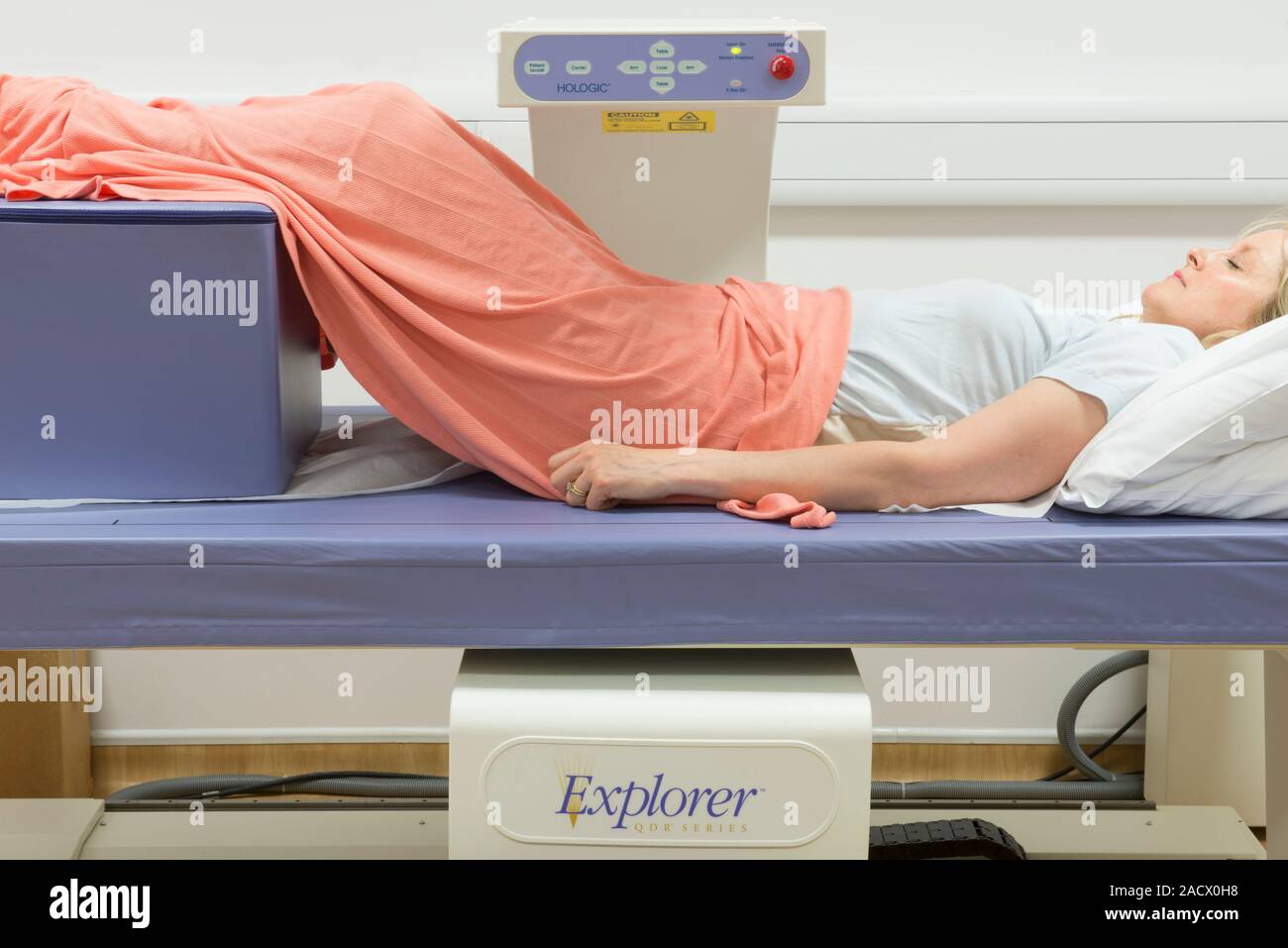Patient lying on a DEXA (dual energy X-ray absorbtiometry) scanner ...