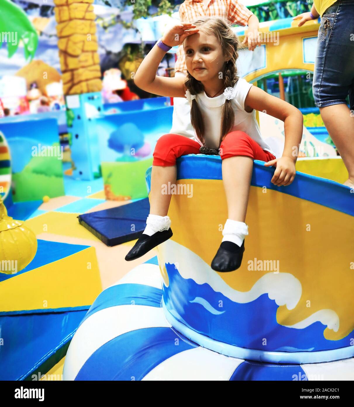 cute little girl playing on inflatable attraction Stock Photo - Alamy