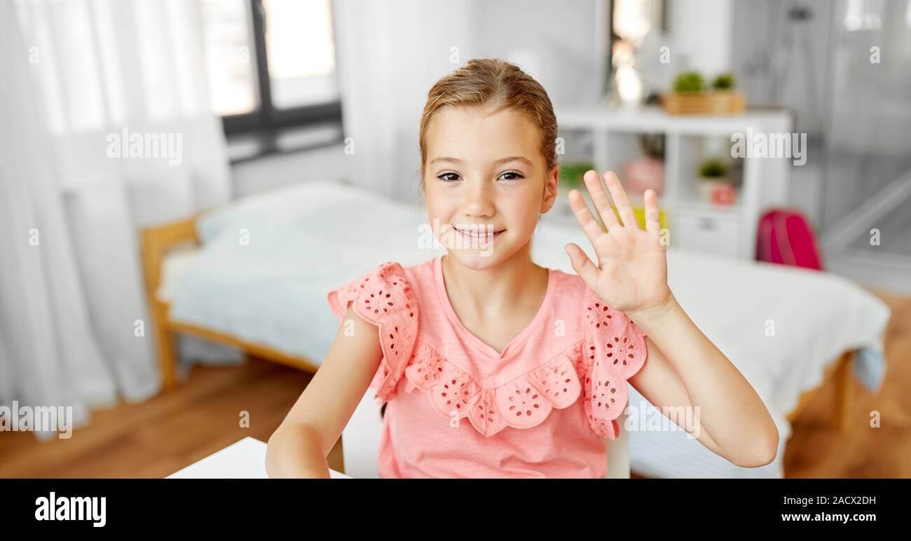 people, children and gestures concept - happy little girl waving hand ...