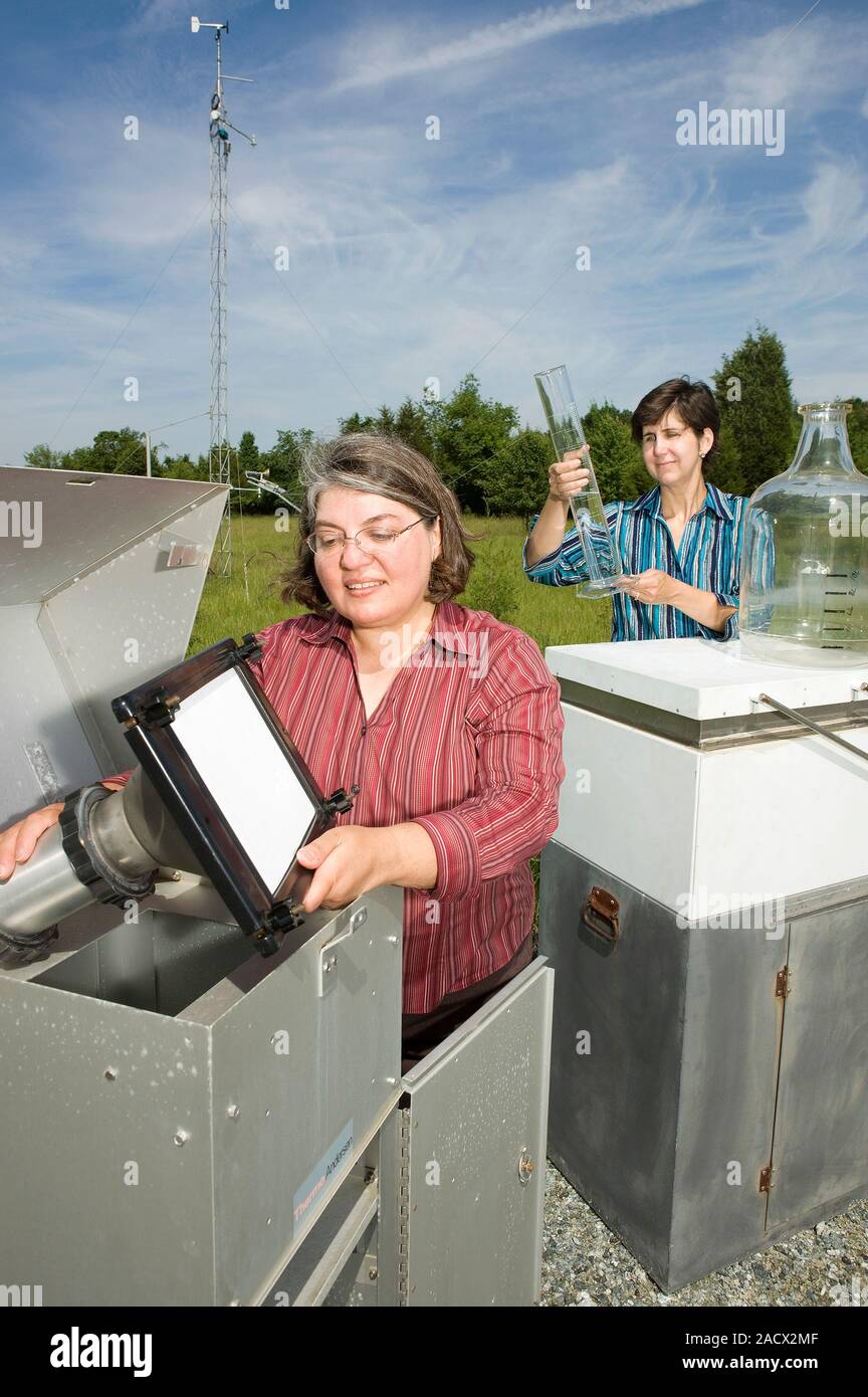 Atmospheric pollutant research. Chemists using air (left) and rain ...