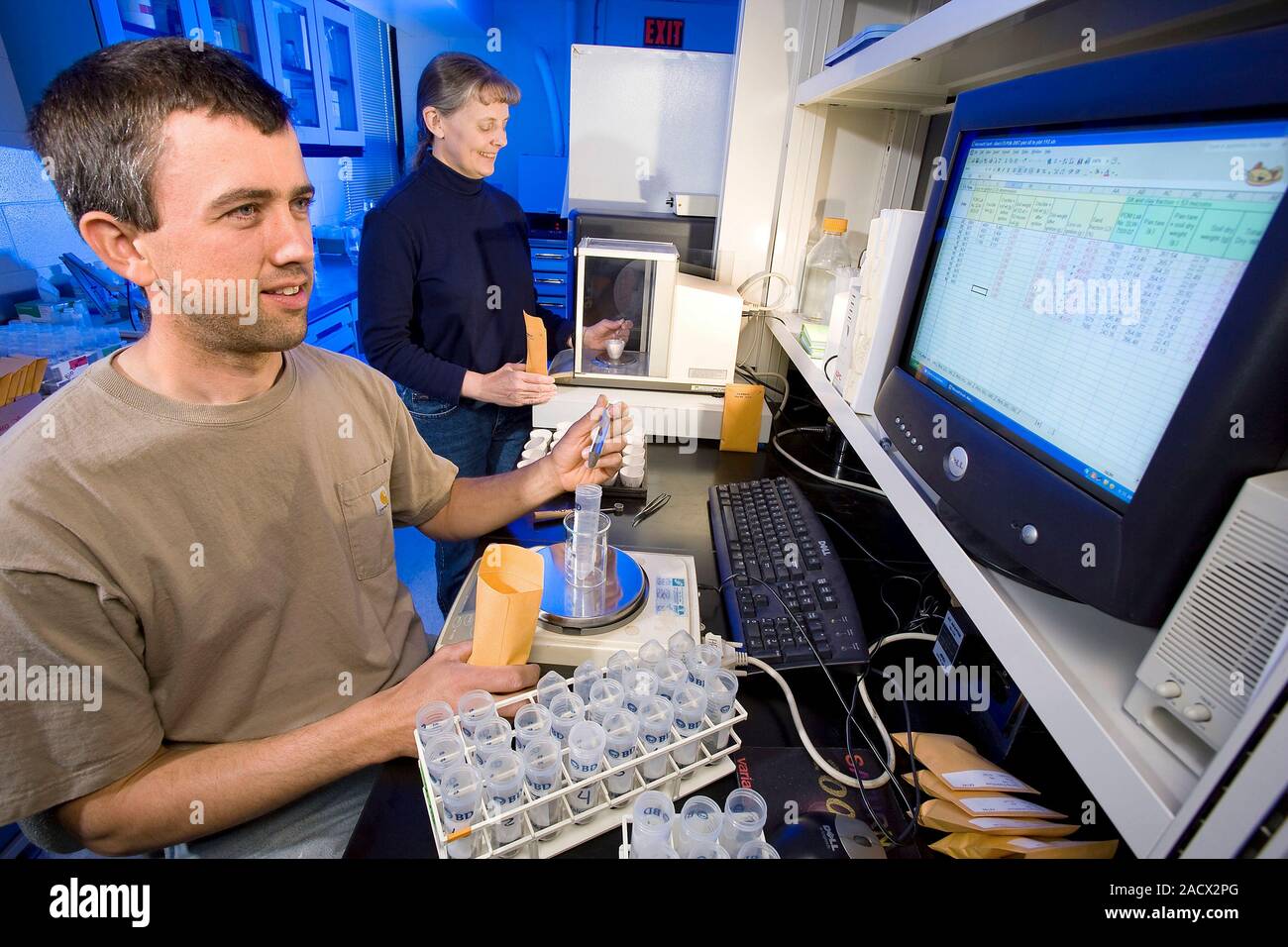Agricultural soil samples analysis. Biological science technician (left ...