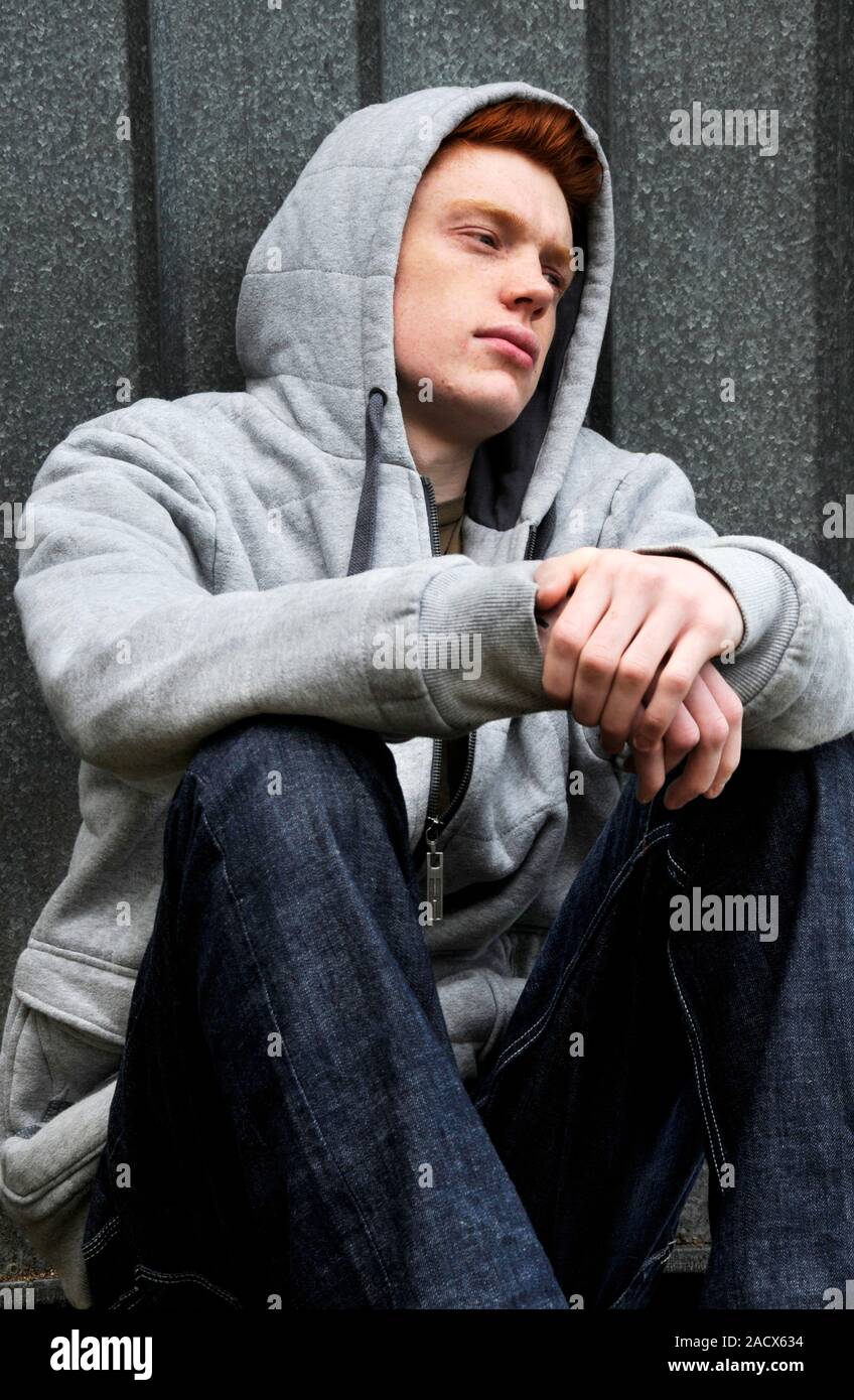 Depressed teenager. 18-year-old depressed teenage boy gazing into the ...
