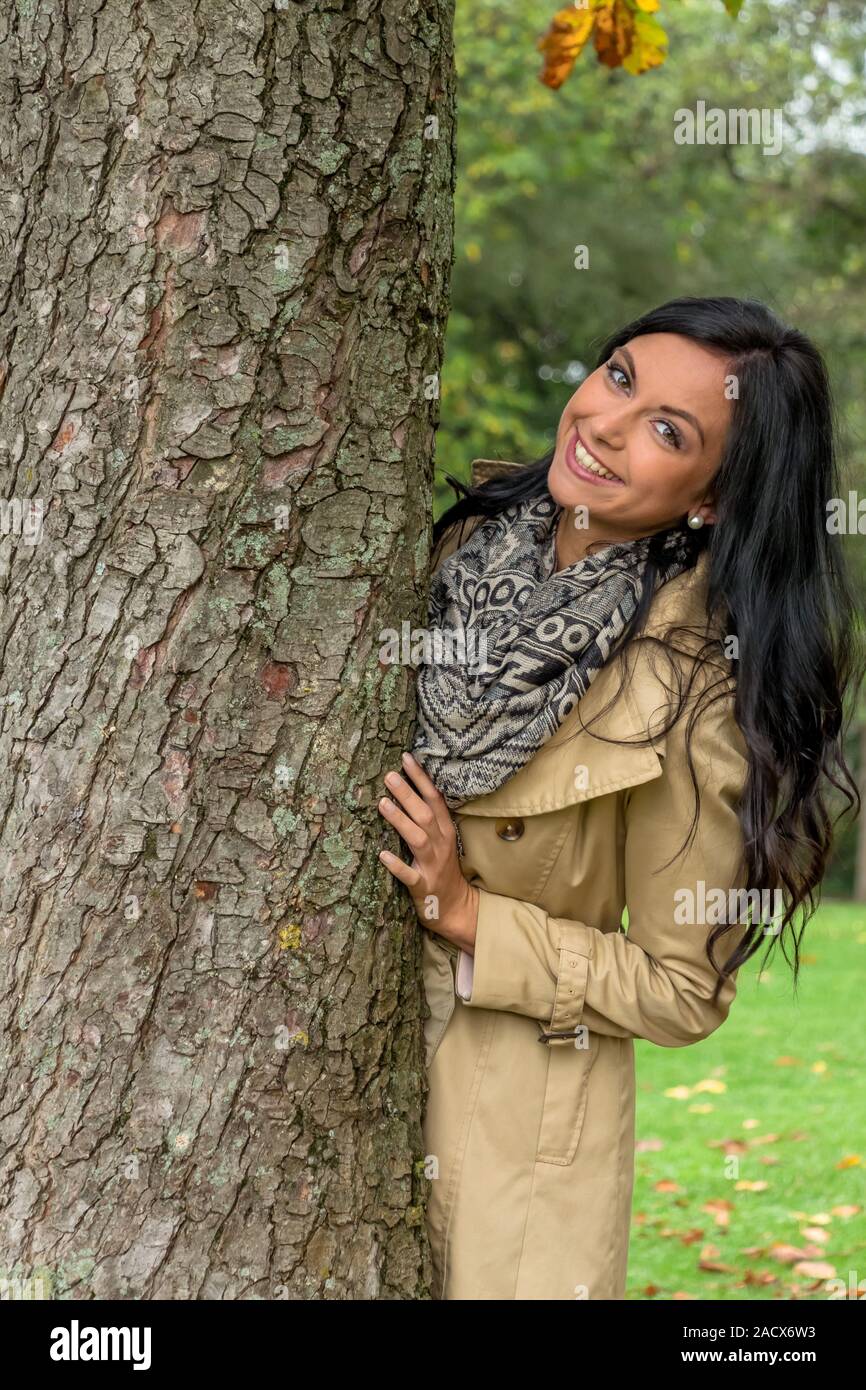 Young woman with tree Stock Photo - Alamy
