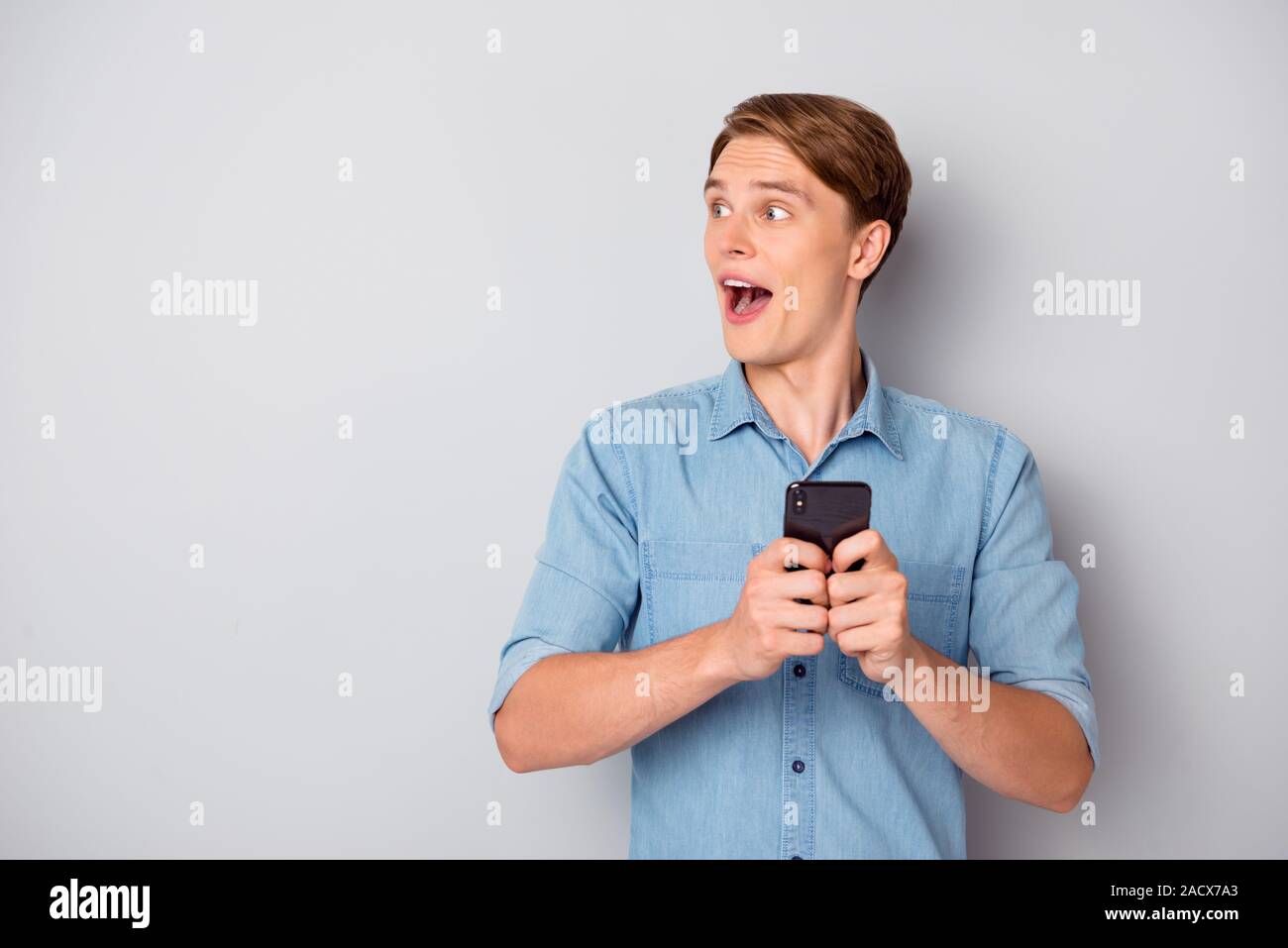 Portrait of astonished guy use cellphone get social media like ...