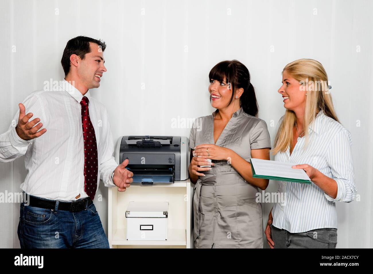 Conversation among employees in the office Stock Photo - Alamy